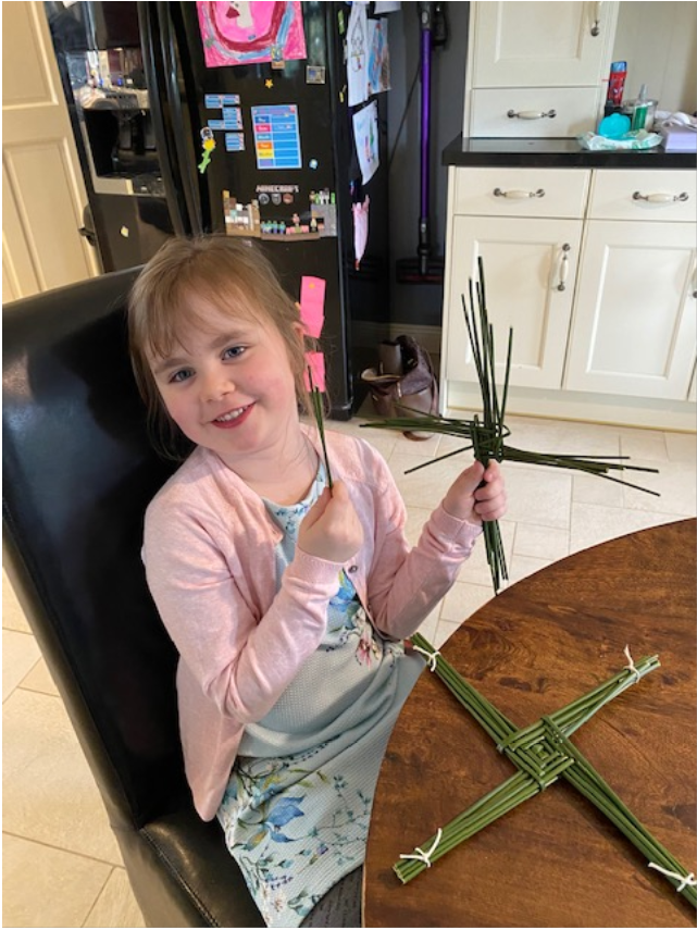 Sorcha making Saint Brigid's crosses